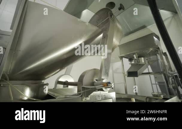 Production of potato chips and snacks. Industrial deep frying machine ...