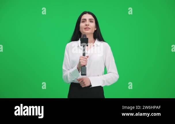 Woman reporter in suit looks into the camera and speaks into a ...