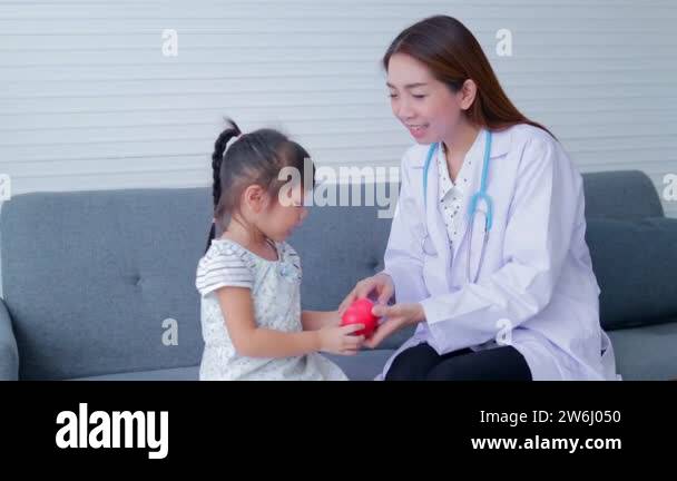 Asian beautiful woman doctor health check up cute little girl They both ...