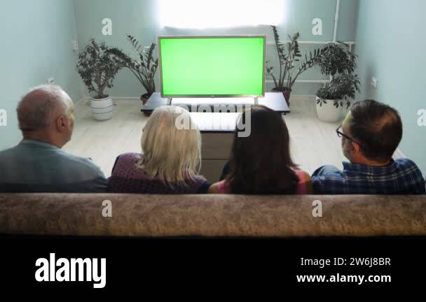 Family watching TV. Green screen. A family of two generations is ...