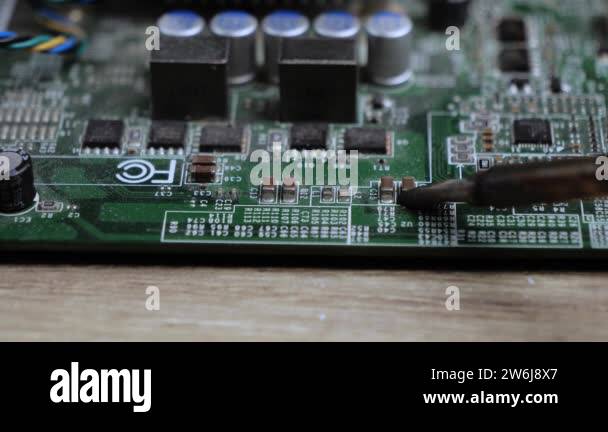 soldering a computer board, changing components with a metal hot ...