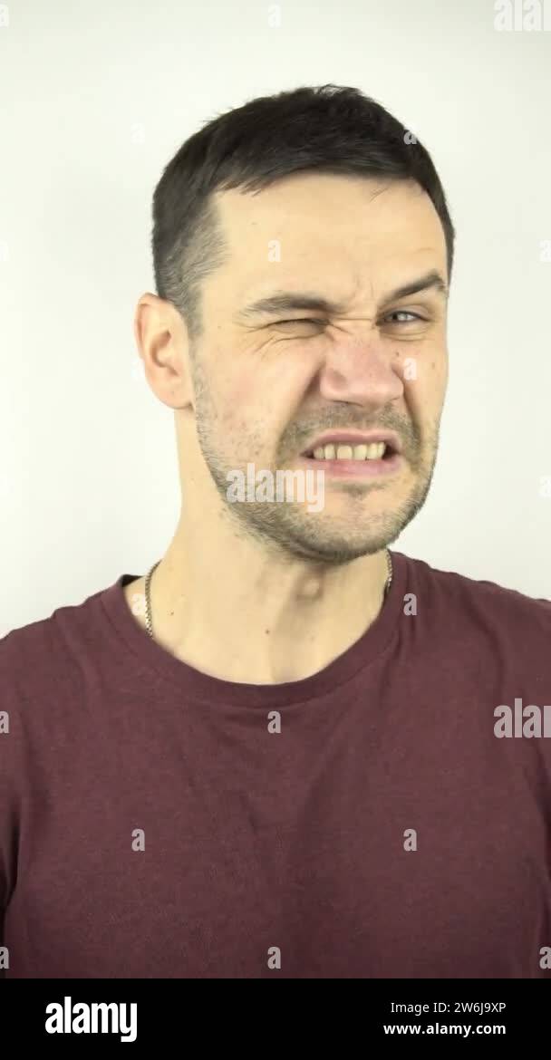 Vertical video. Young attractive guy gets a slap in the face from his ...