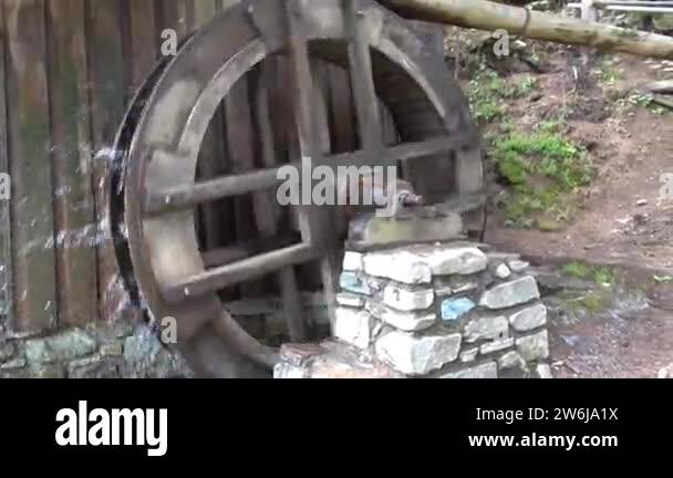 large water wheel with brooks and wooden railings and steps in a gorge ...