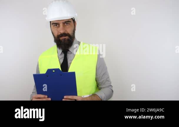 Engineer with beard wearing work helmet and reflecting jacket, holding ...