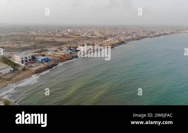 Front View Of Houses In The Karachi Beach With Sea - Pan Right To Left ...