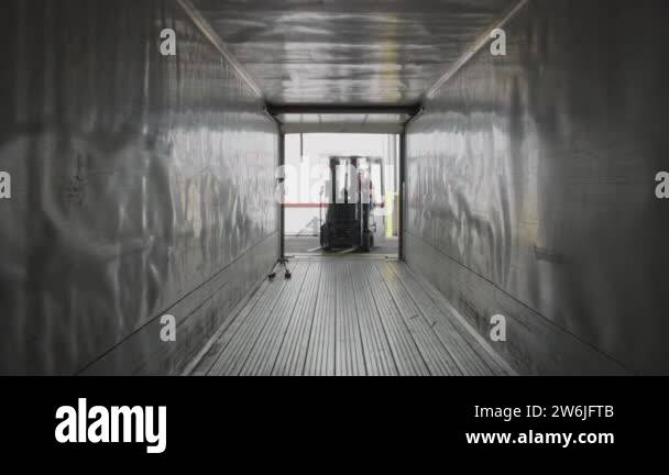 Forklift driving into semi truck trailer. Fully released for commercial ...