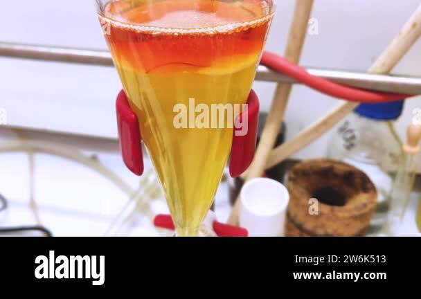 Separation of organic layer and water layer in separating funnel in a ...