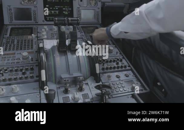 Back view of crop anonymous male captain and pilot sitting in cockpit ...