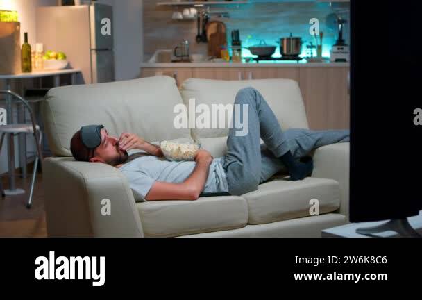 Man lying on sofa, falling asleep in fron of the TV Stock Video Footage ...