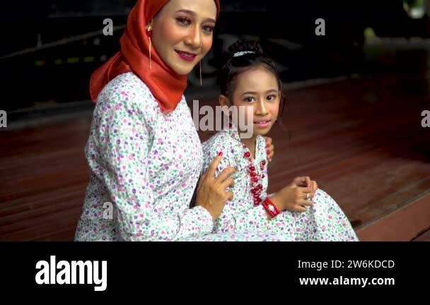 4k footage of mother and daughter moment, outdoor wearing traditional ...