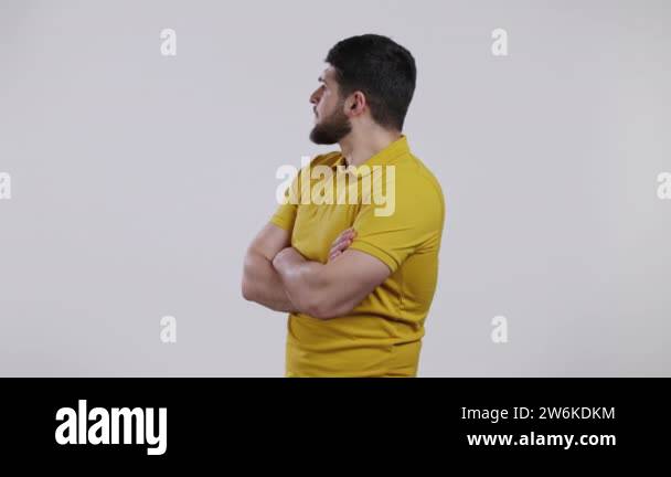 Angry offended man keeping arms crossed and staring at camera with ...