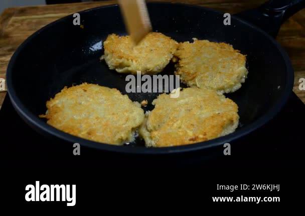 Toasted crispy crust golden potato pancakes or deruny fried in boiling ...
