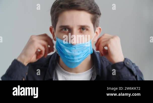 Portrait of caucasian millennial man teaches showing correct wearing of ...