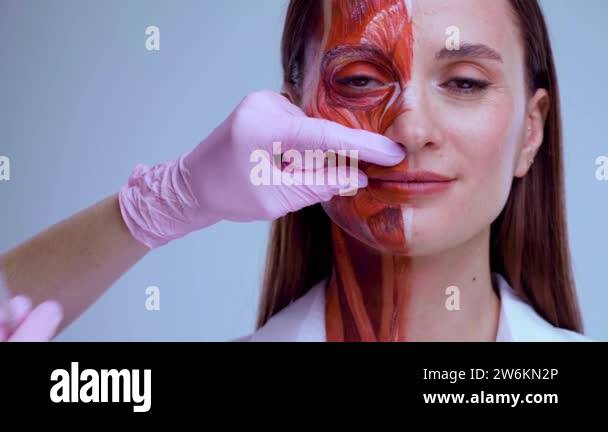 Botox injection in the face. Young woman with half of face with muscles ...