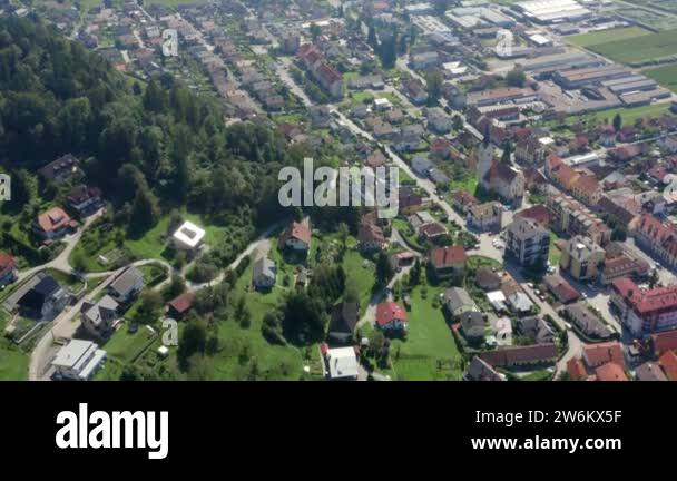 A typical town with farms on the side of center with main road passing ...