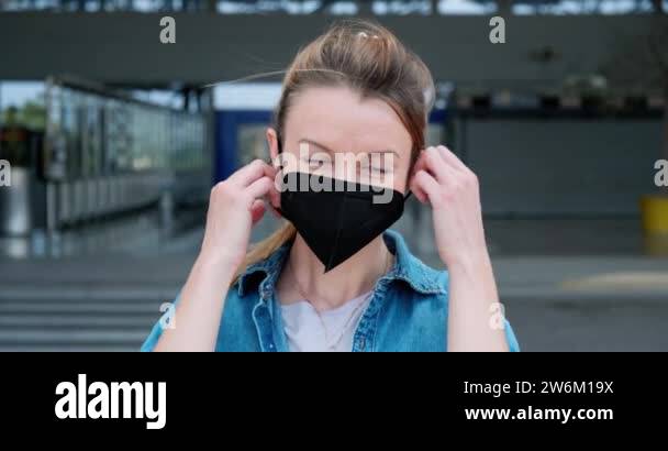 girl in a black mask looking at the camera, girl taking off the mask ...