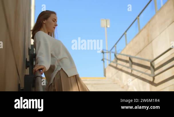 Model with long legs and dressed in mini are posing in slow motion in ...