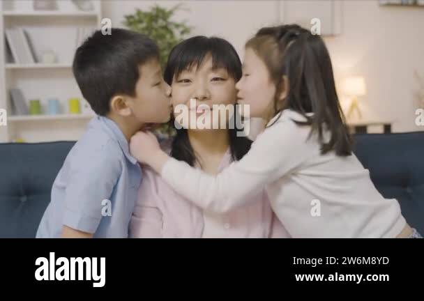 Sweet asian kids kissing mother on cheeks, parent and child relationship, family Stock Video ...