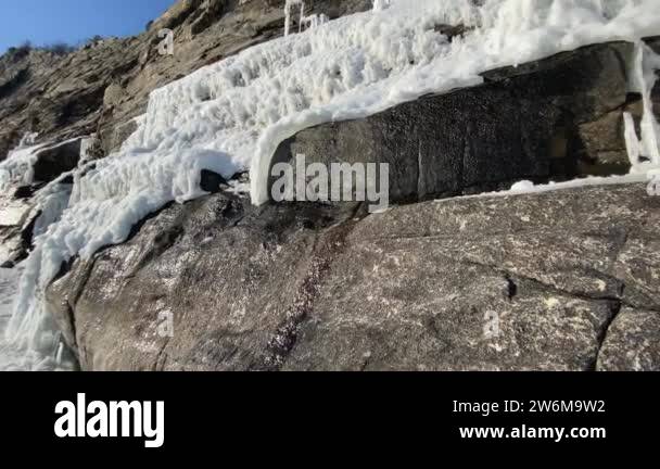 Spring in the mountains. Streams run down the steep cliffs. Snow and ...