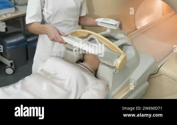 Woman doctor radiologist makes brain, head, neck MRI scanning. Young ...