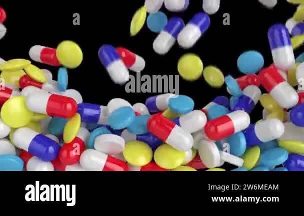 Bright colored pills and capsules falling from above on a transparent ...