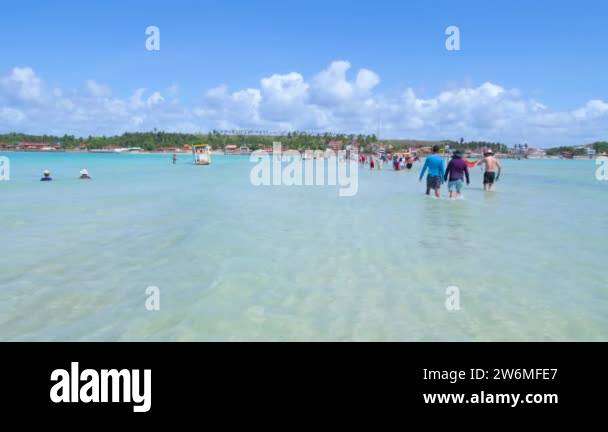 People walking in the middle of the sea at the Moses path, Maragogi AL ...