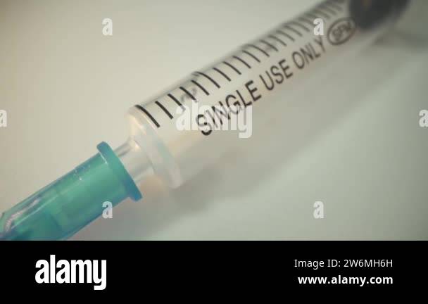 Medicine. Disposable syringe with a needle on a white surface. The sign ...