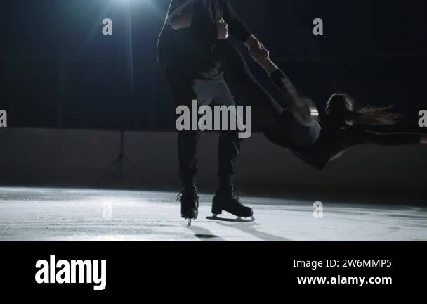 man and woman are performing figure skating lift and spin, professional ...