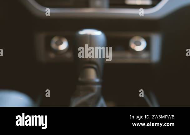 A mans hand shifting a gearbox in the modern auto. Man shifting a stick ...
