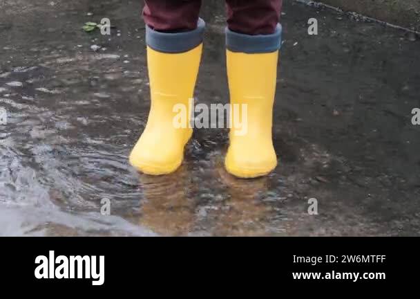 Jump through puddles in yellow rubber boots. Walk in rain and enjoy the ...