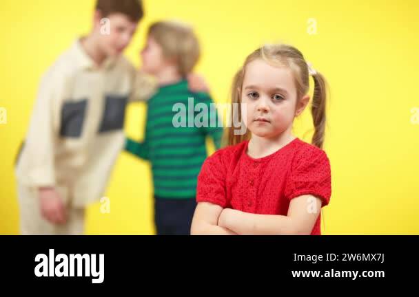 Sad charming little girl with crossed hands looking at camera as ...