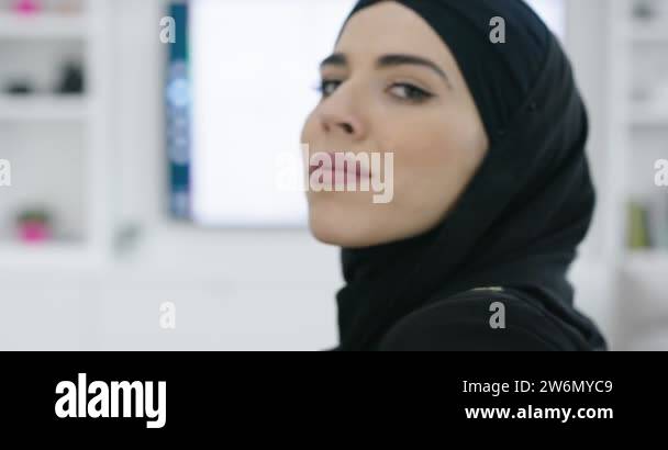 Portrait of young muslim woman wearing islamic hijab clothes sitting on ...