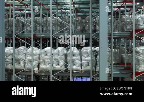 Logistics warehouse. White bags on pallets. Shelving. Cargo. Cargo ...