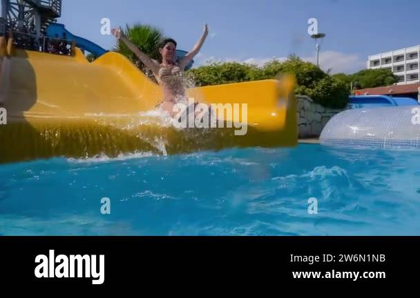 Descent from the waterslide on holiday aqua park. Slow motion on a ...