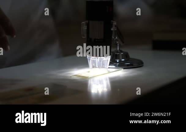 Electron microscope used to conduct grain quality analysis in a dark laboratory Gorgeous view of ...