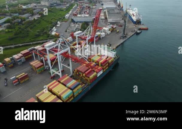 4K modern industrial port with containers from top or bird's eye view ...