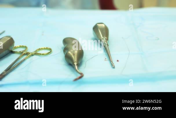 Surgical dental instruments on the table during tooth extraction ...