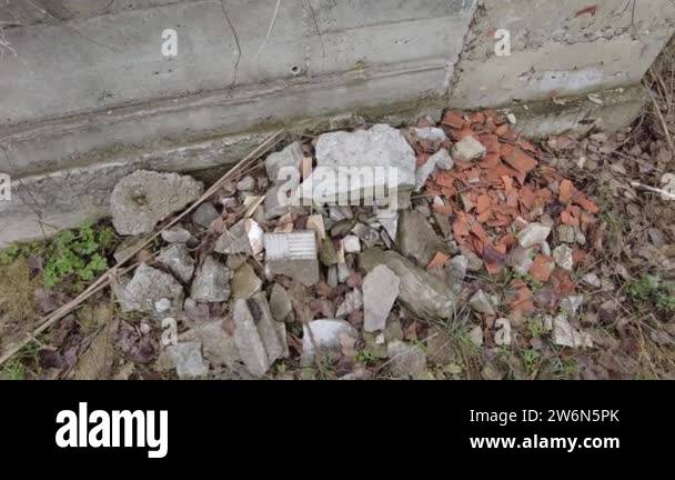 a pile of construction waste. broken brick and concrete. shards of red ...