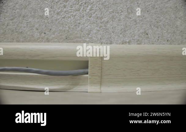 Installation of a skirting board in the apartment and hiding the cable ...