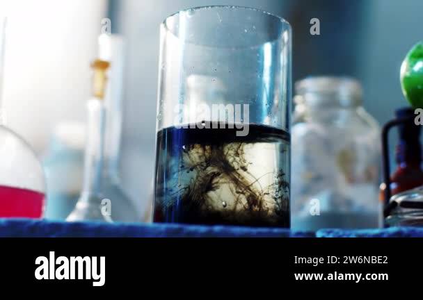 Details in the chemistry lab chemical reaction of a flask full of black ...