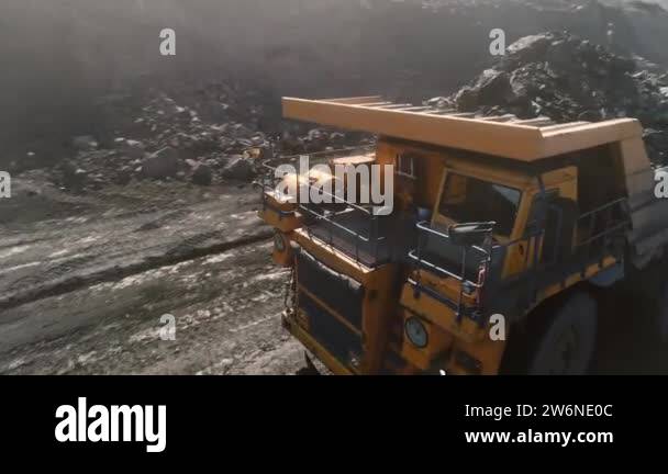 Large quarry dump truck. Loading rock in dumper. Loading coal into ...