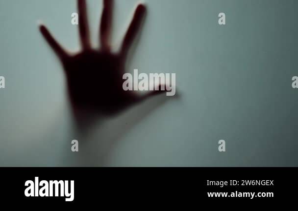 Marco hand waving behind frosty glass. Female fingers sliding on glass ...