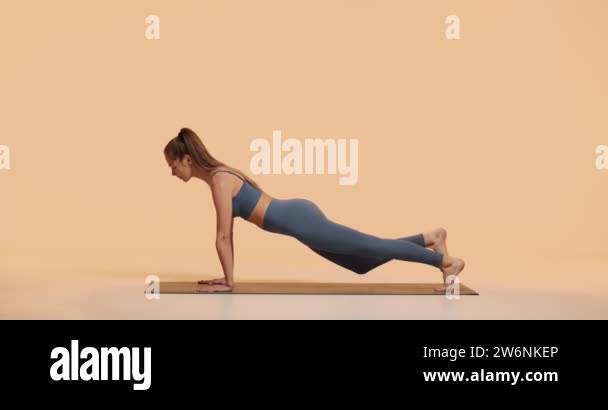 Yoga workout, surya namaskar practice. Young slim flexible girl ...