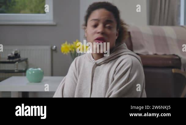 Anxious sick African American woman looking around with scared facial ...