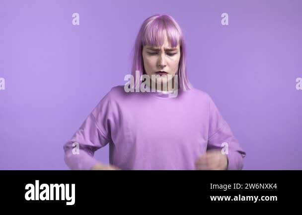 Angry offended woman with dyed purple hair keeping arms crossed and ...
