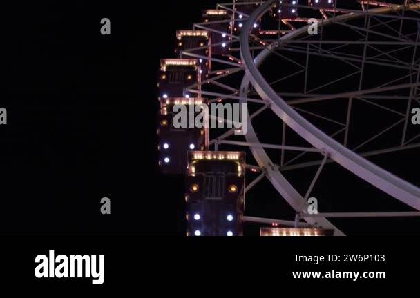 Ferris Wheel Lights at Night. Neon colored lights flashing on the ...