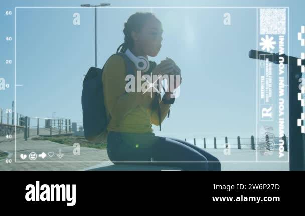 Digital animation of video game interface against woman having a snack ...