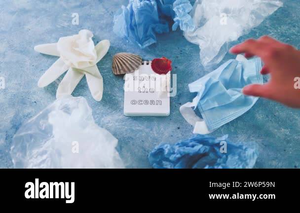 save the ocean text on blue background with sea shells and plastic ...