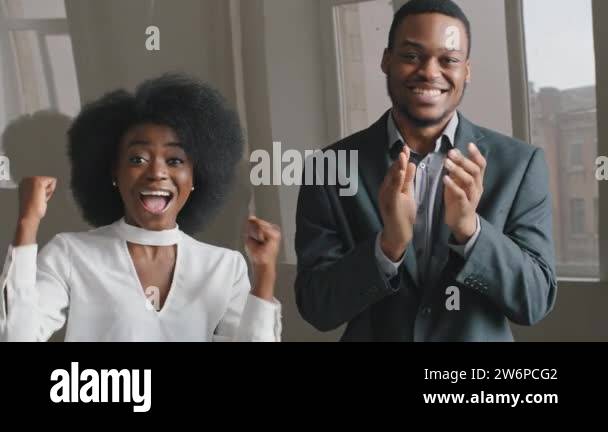 Excited ethnic African American office workers rejoicing win shouting ...