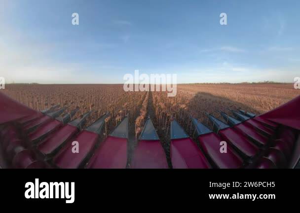 Front view of tractor with harrow system plowing ground on cultivated ...